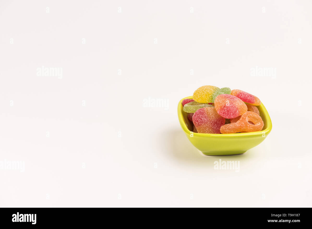 Small bowl with gummy candies isolated on white background Stock Photo ...