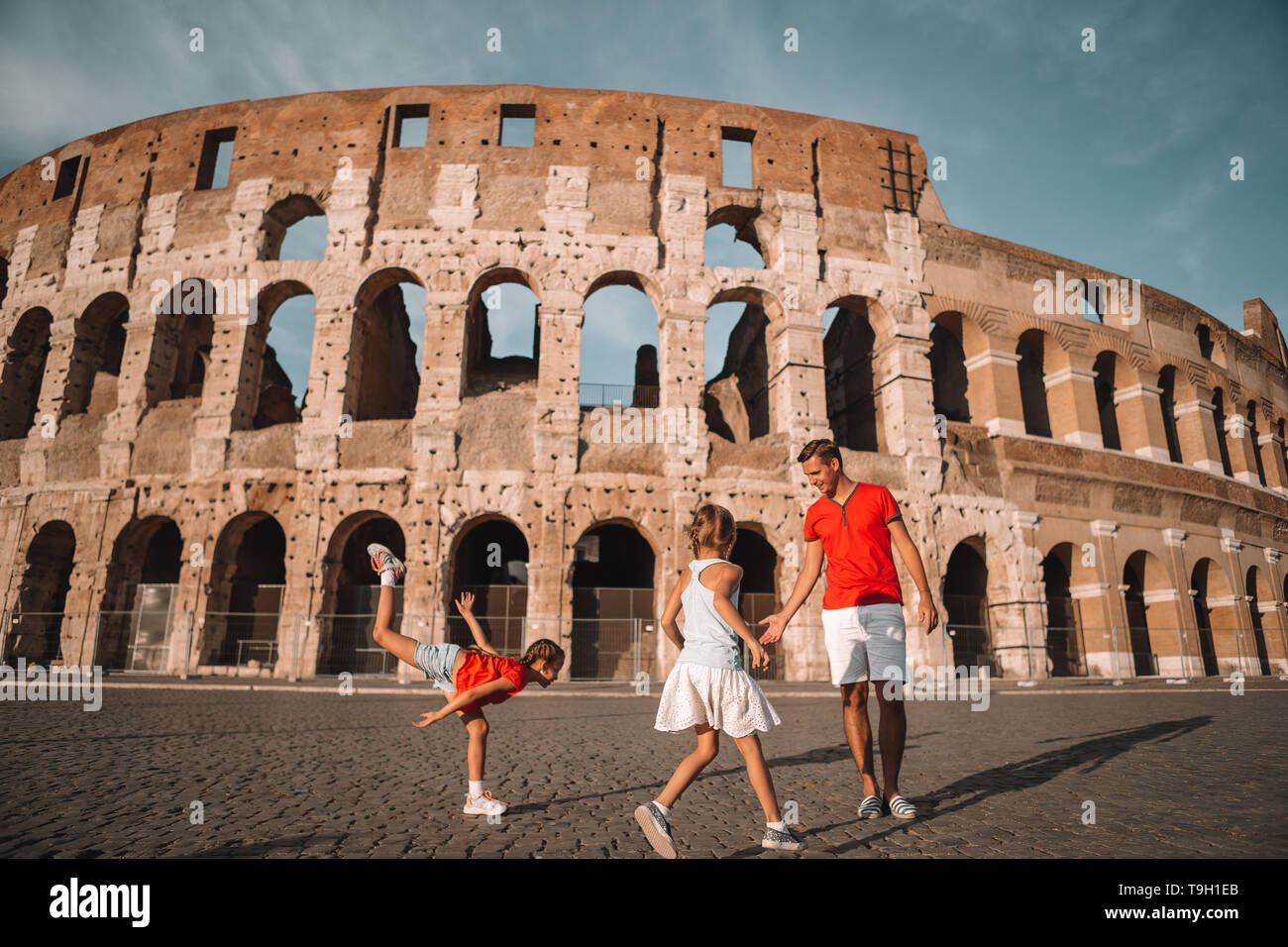 Happy family in Europe. Parents and kids in Rome over Coliseum ...