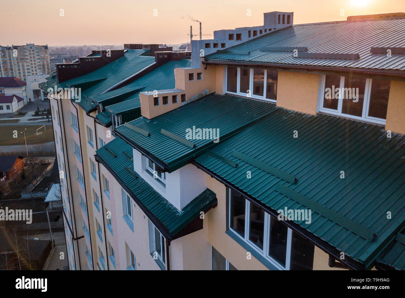 Aerial view of attic annex room exterior with plastic windows, roof and ...