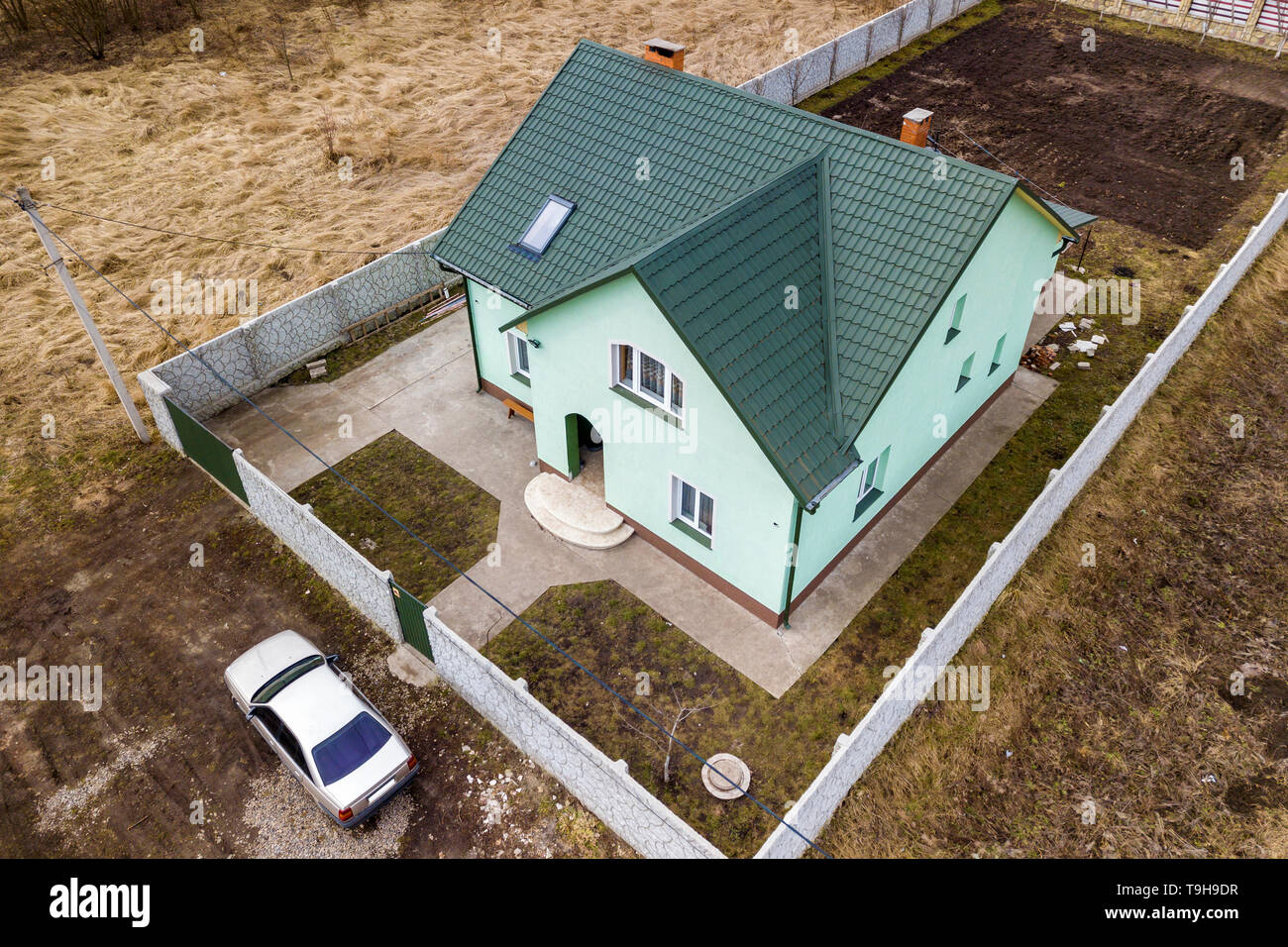 Aerial top view of new residential house cottage with brick chimney and ...