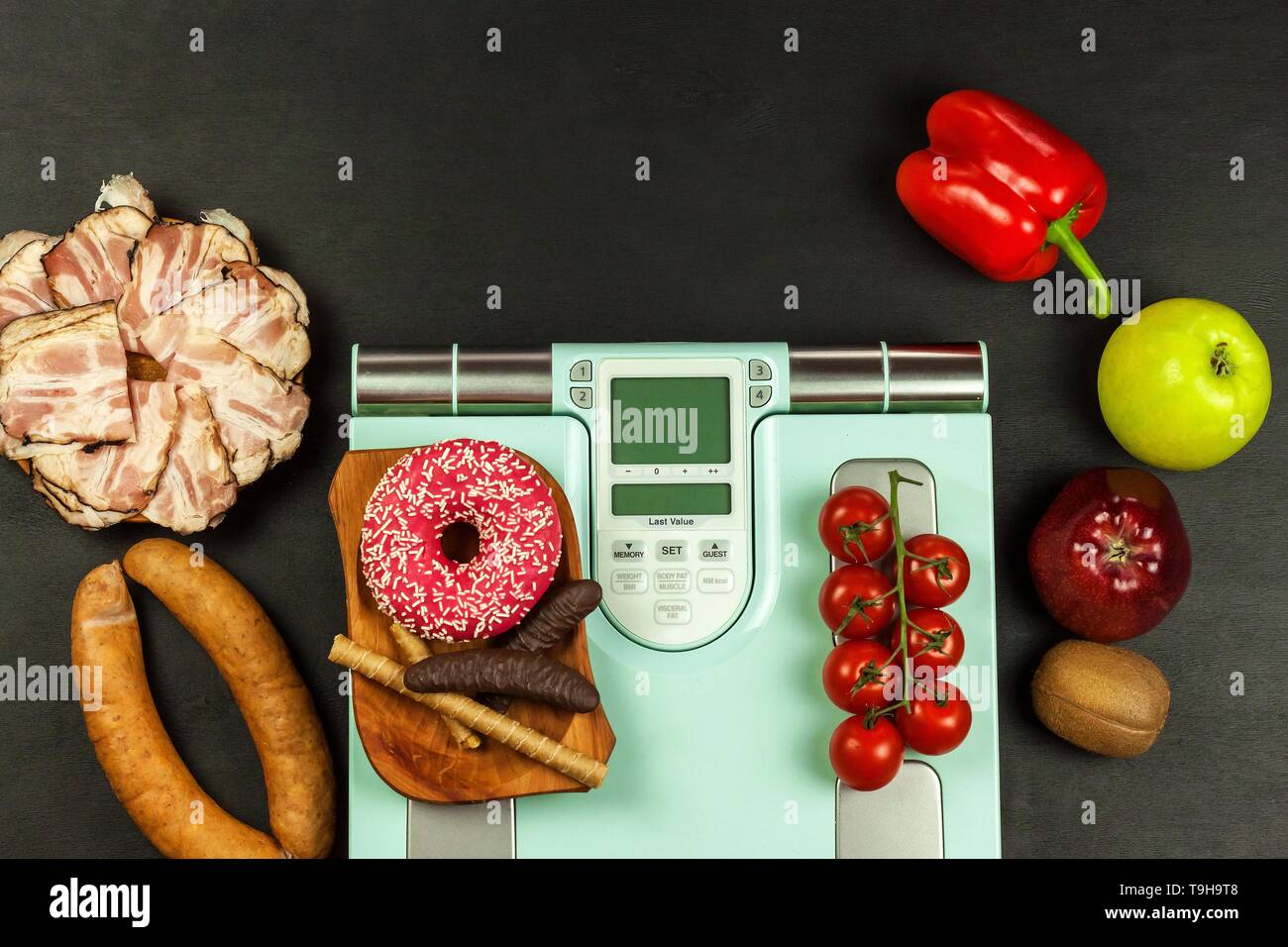 Healthy and unhealthy food. Obesity concept. Modern digital weight and ...