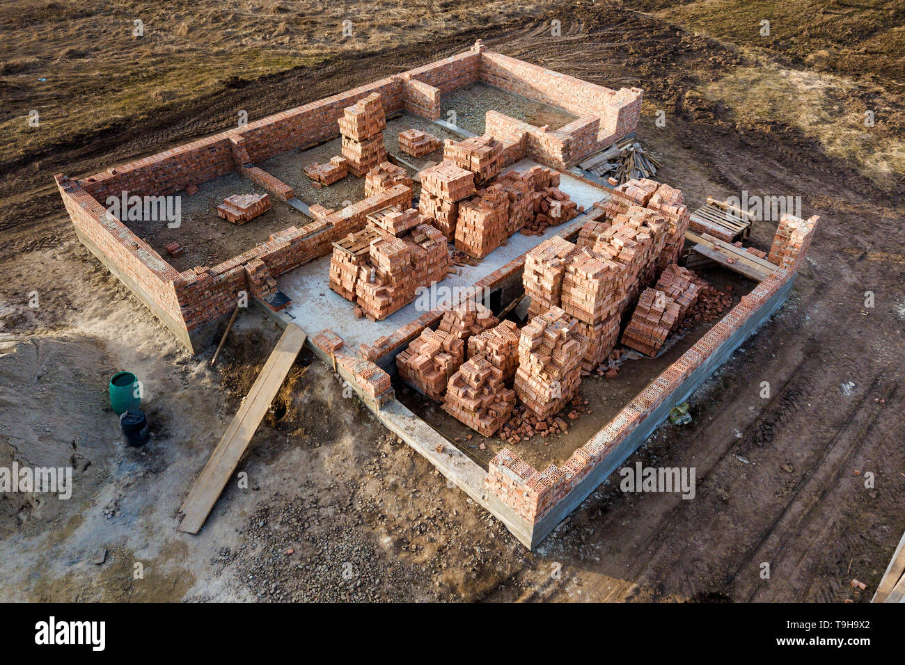 Aerial view of building site. Trenches dug in ground and filled with ...