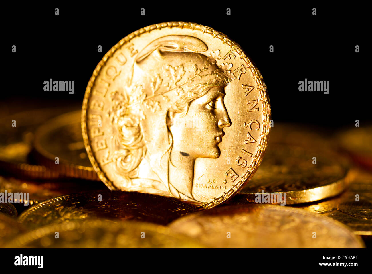 Real Gold coins over dark background Stock Photo - Alamy
