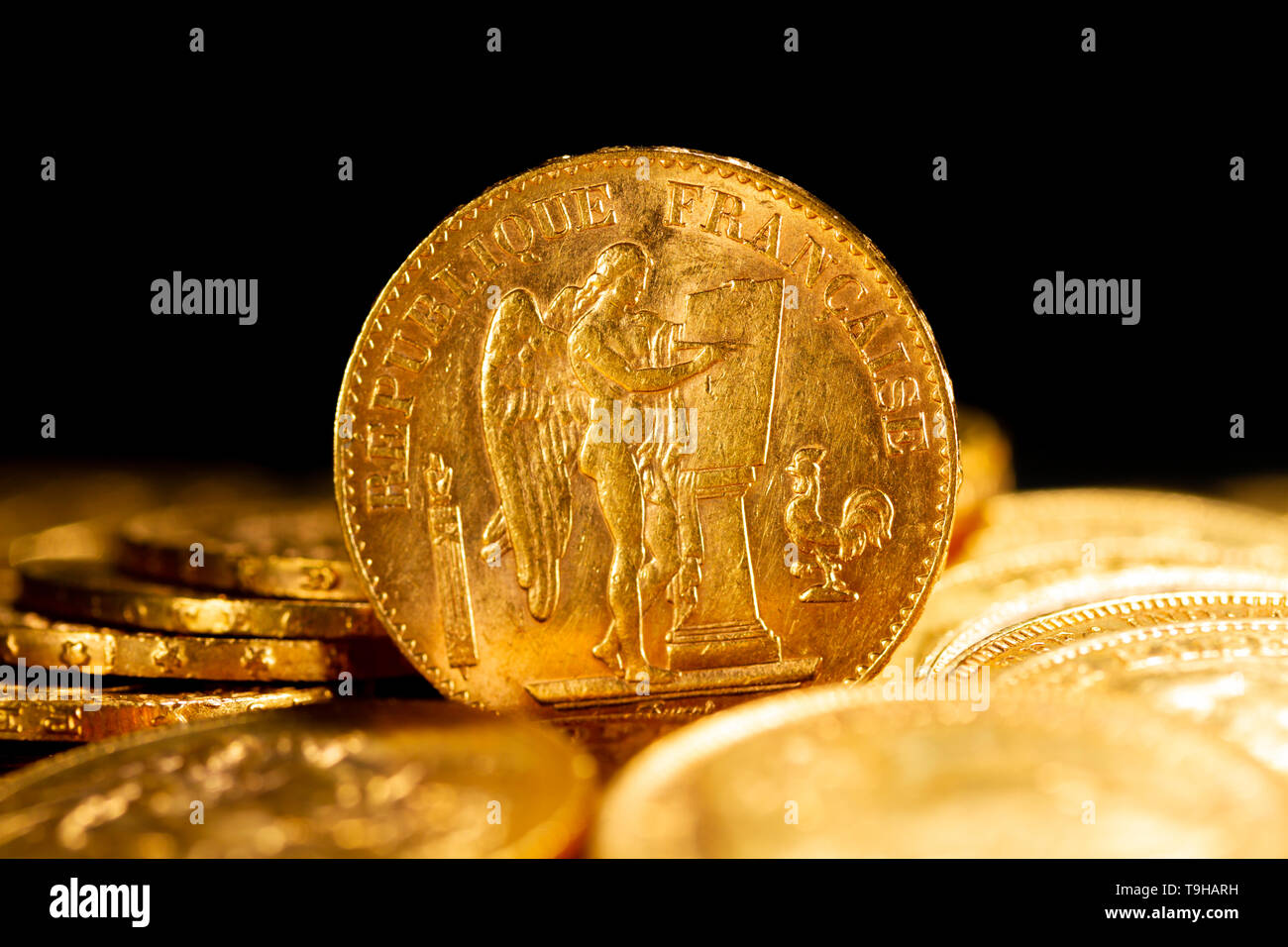 Real Gold coins over dark background Stock Photo - Alamy