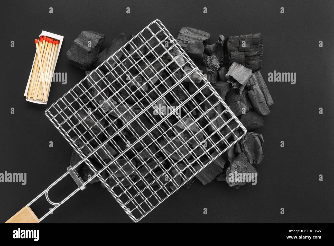 Barbecue grill grid on charcoal pieces and a box of matches. BBQ ...