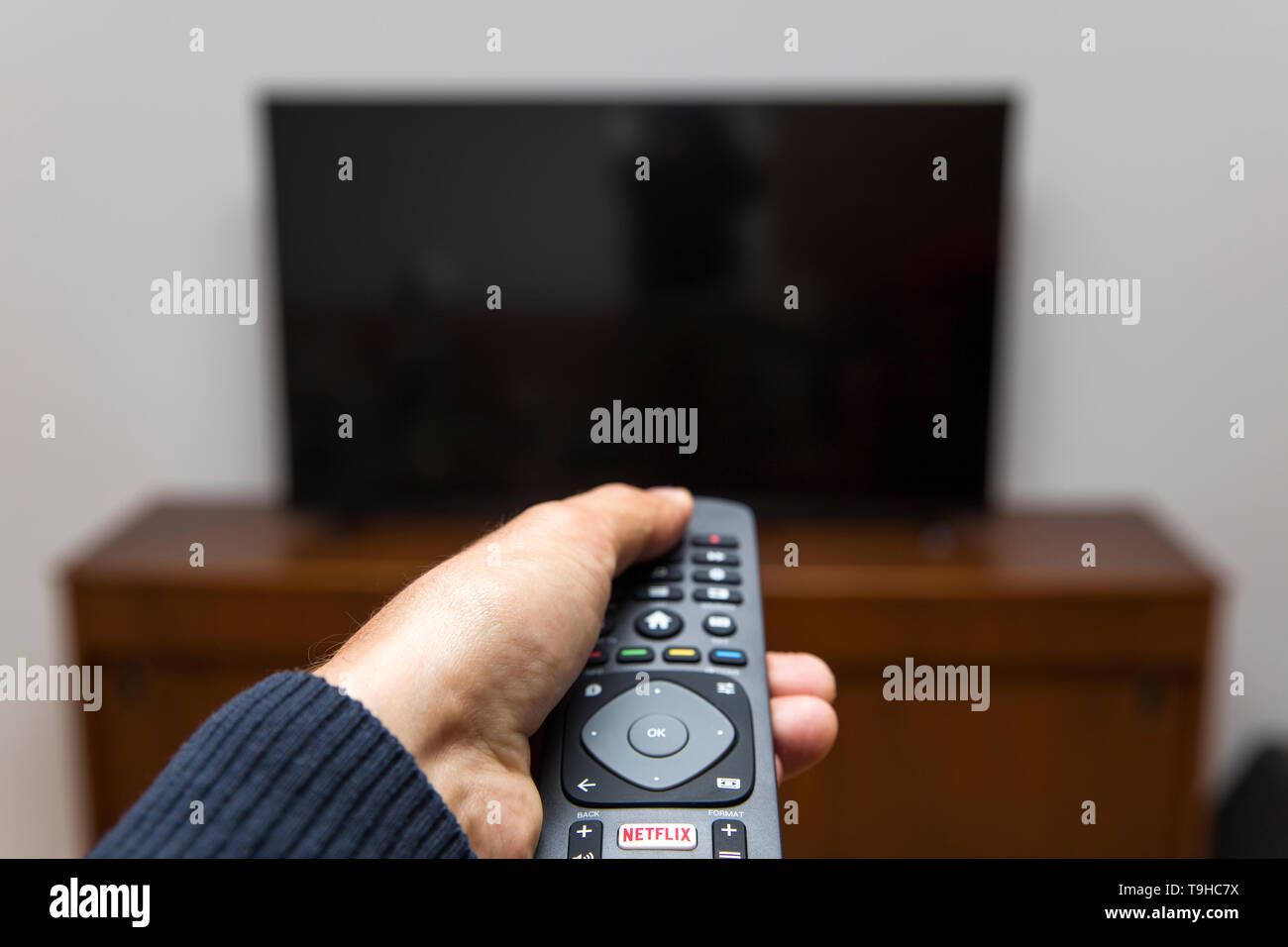 BELGRADE, SERBIA - MAY 9, 2019: Hand holding an Netflix remote control ...