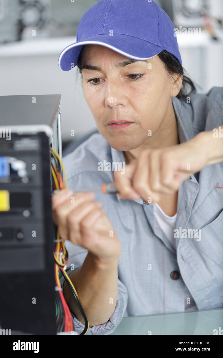 mature female unscrewing a pc Stock Photo - Alamy