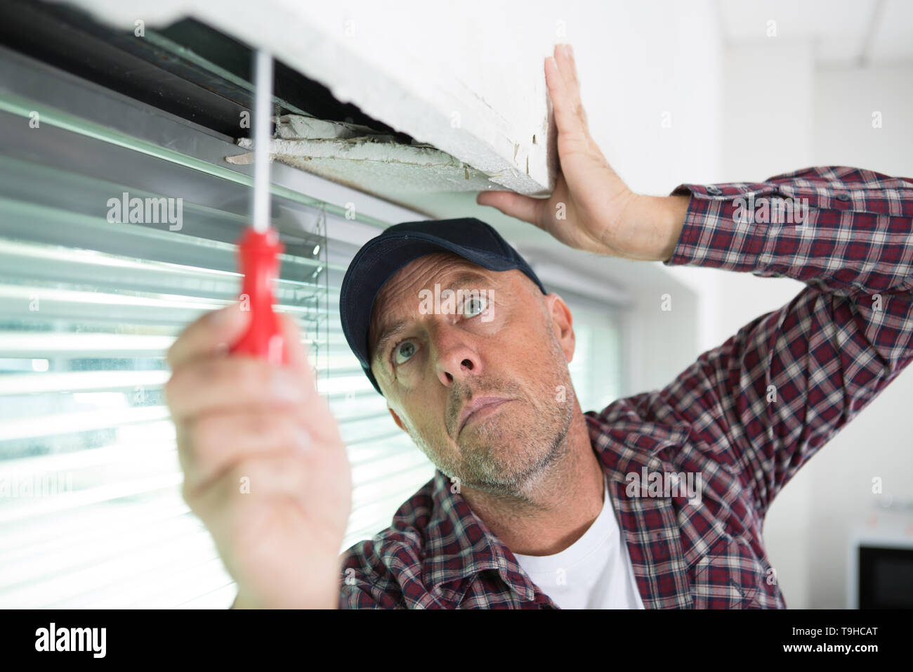 handyman repairing a window Stock Photo - Alamy