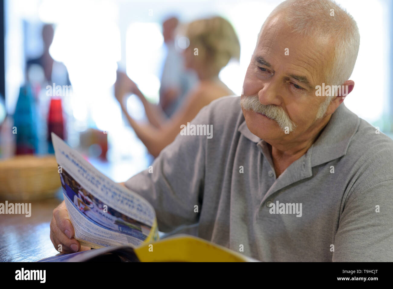 elderly man reading magazine Stock Photo - Alamy