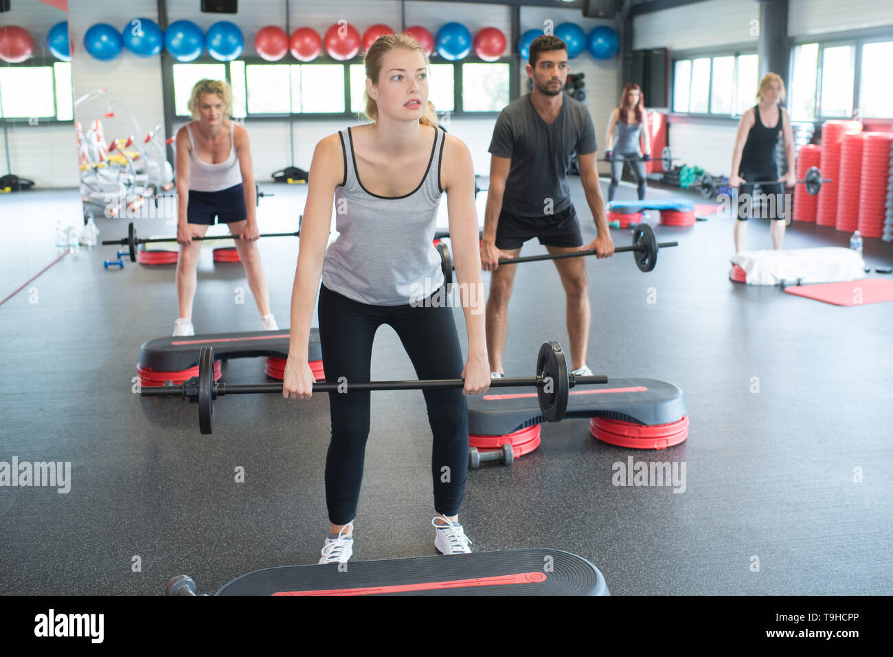 people in step exercise class holding weights Stock Photo - Alamy