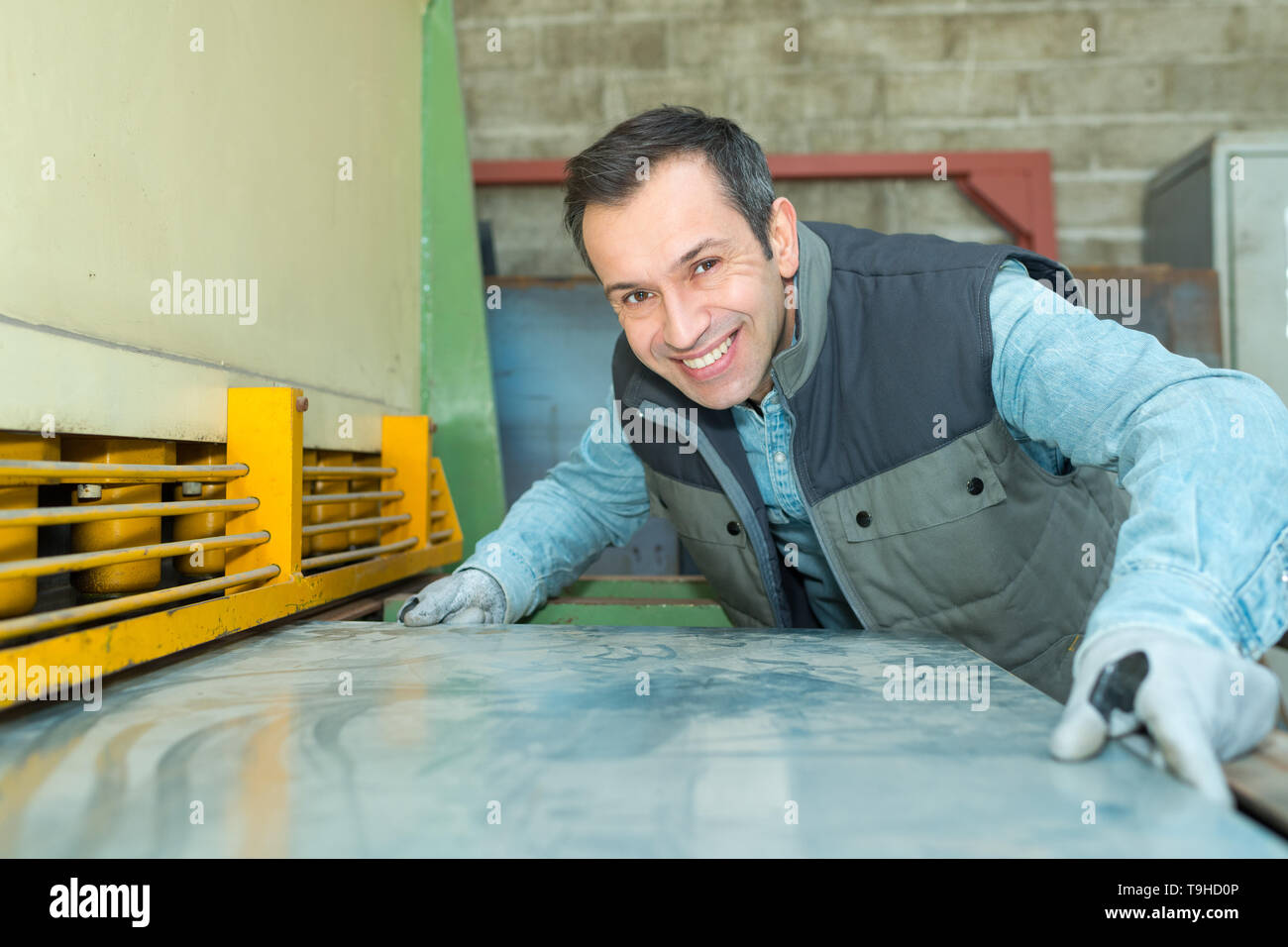 portrait of middle aged man working with sheet metal Stock Photo - Alamy
