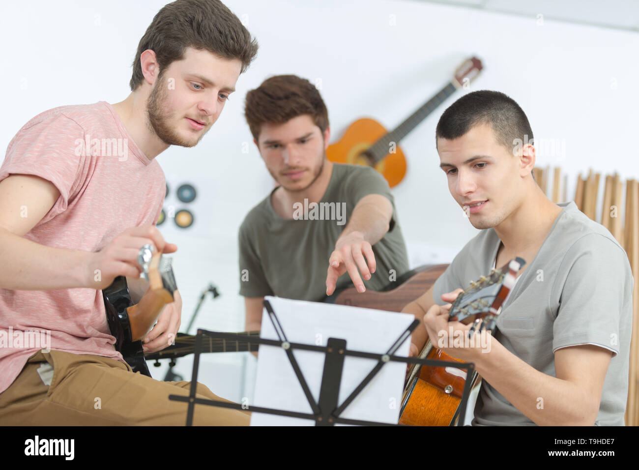 three teenagers playing music at home Stock Photo - Alamy