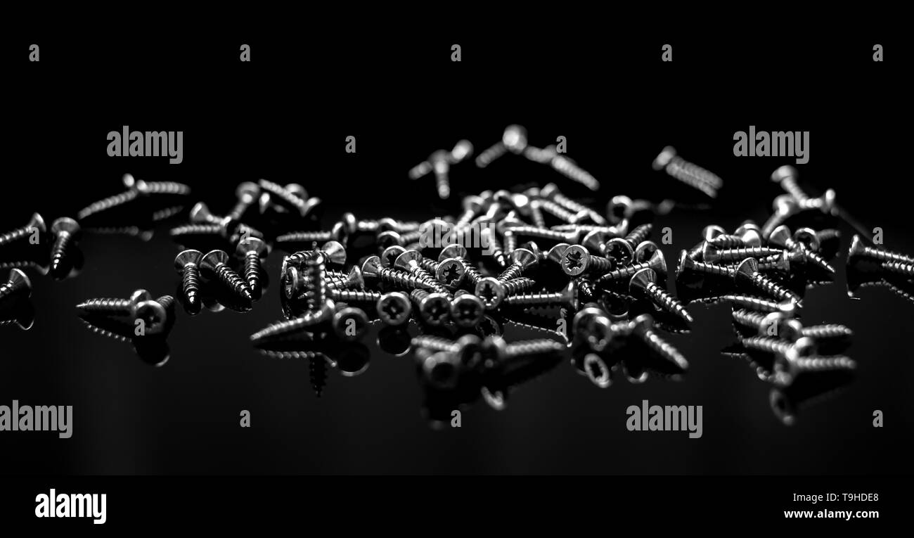 screws on black background Stock Photo - Alamy