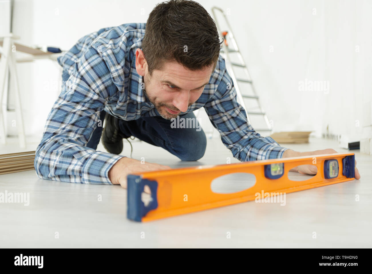 man measuring wooden plank Stock Photo - Alamy