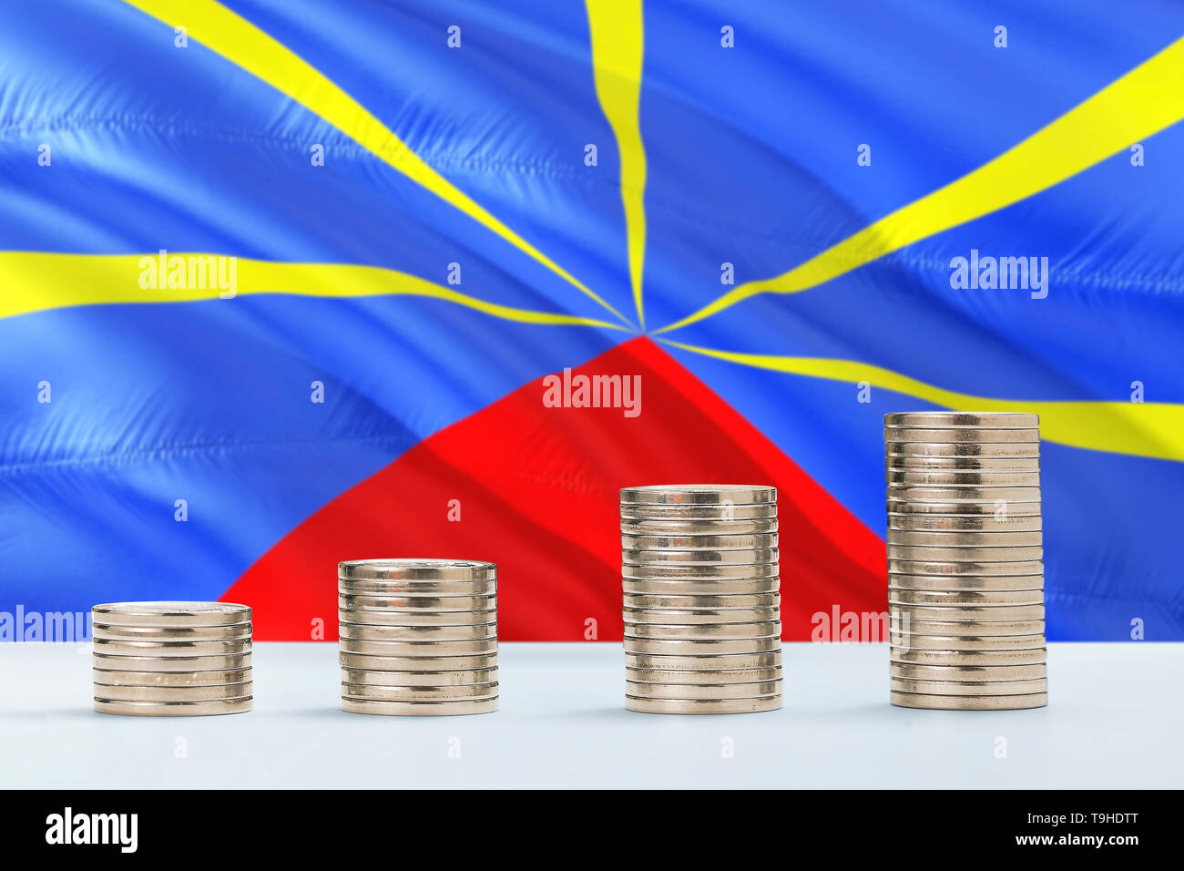 Reunion flag waving in the background with rows of coins for finance ...
