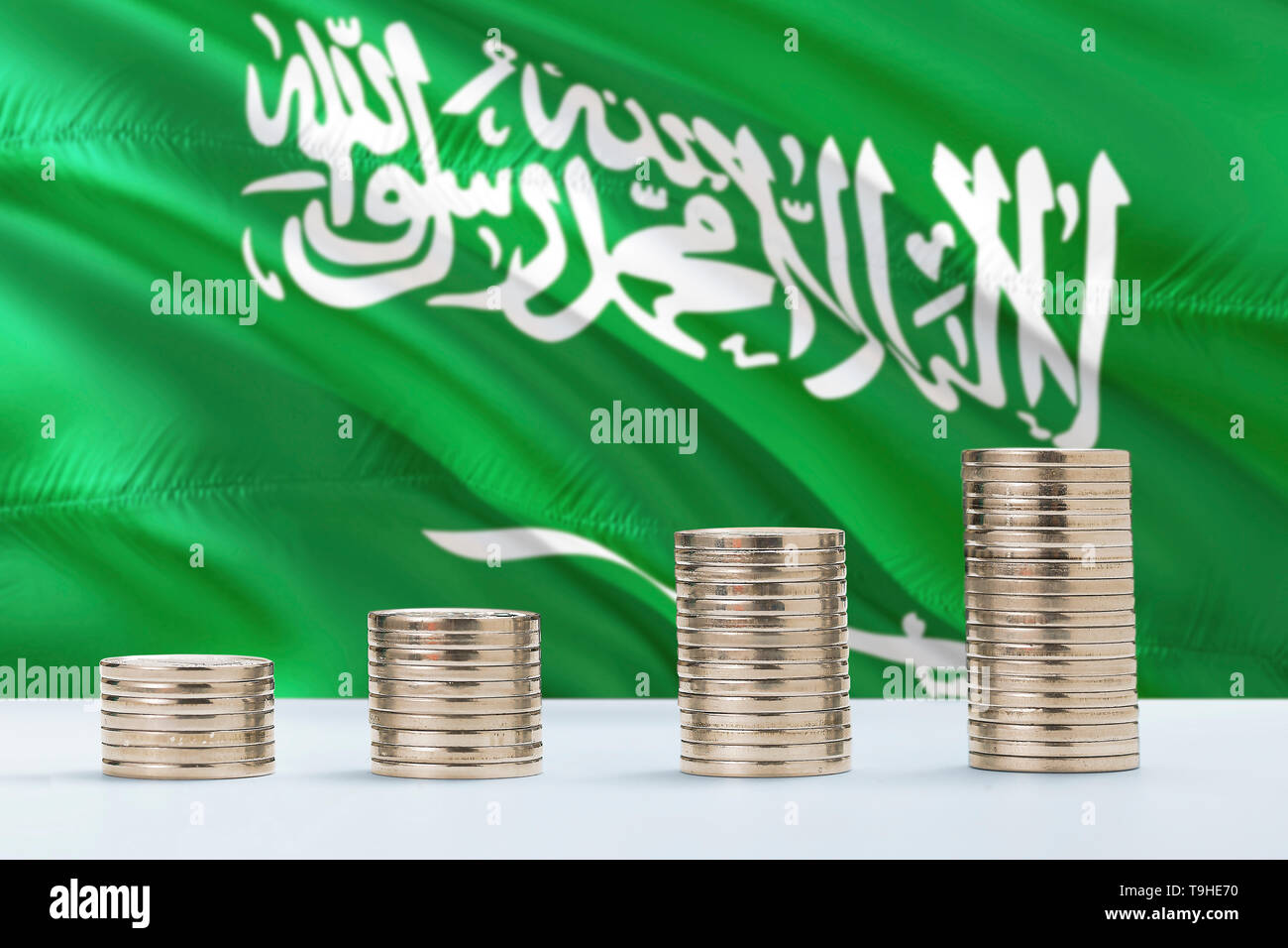 Saudi Arabia flag waving in the background with rows of coins for ...