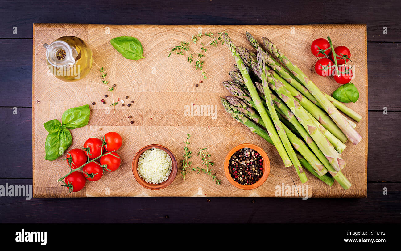 Fresh green asparagus on a rustic wooden table with copy space. Top ...