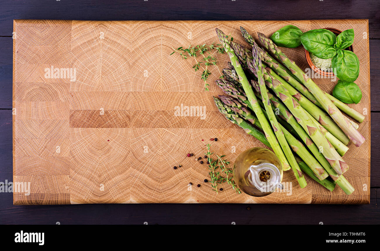 Fresh green asparagus on a rustic wooden table with copy space. Top ...