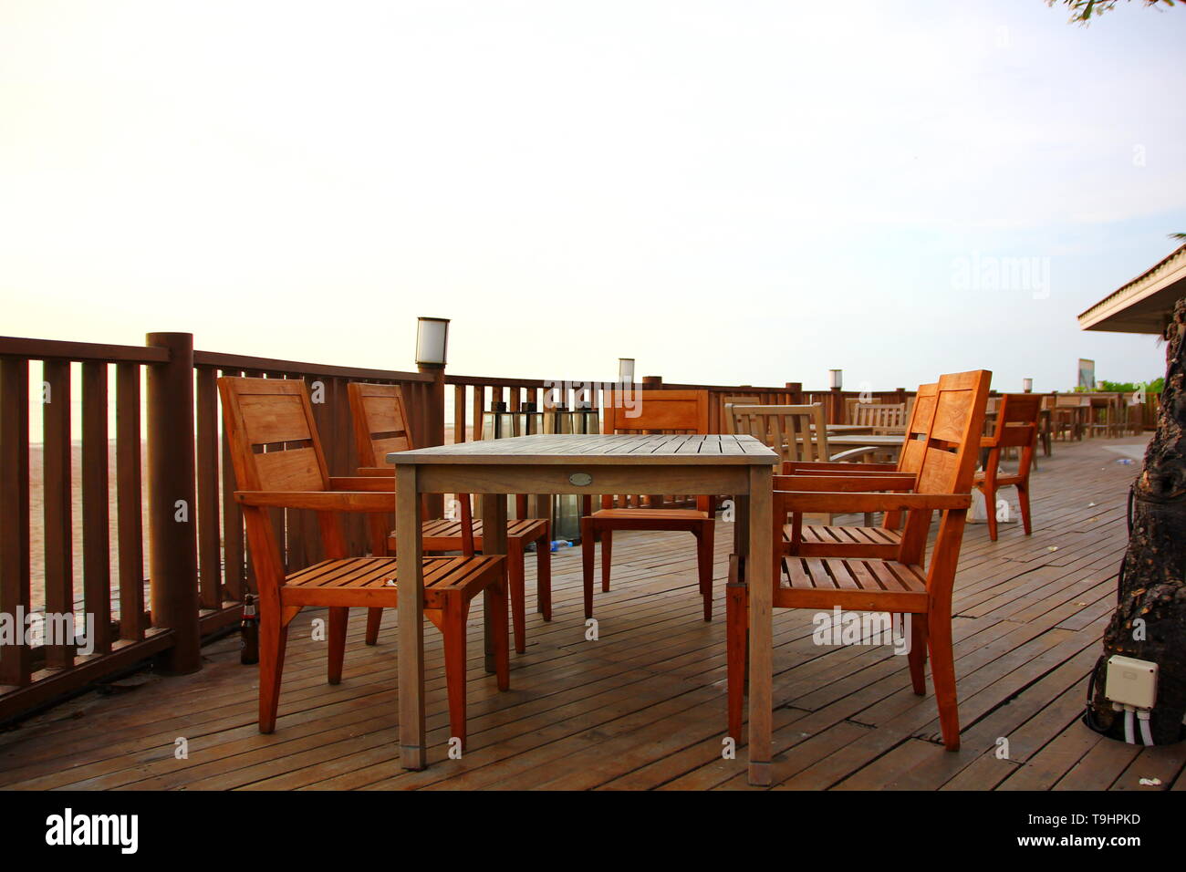 wood terrace with wooden table and desk on beach at sea view point.the ...