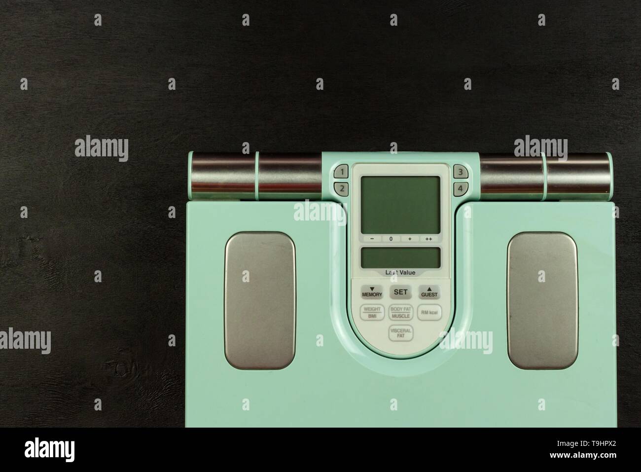 Obesity concept. Modern digital weight and legs. Weight control on diet ...