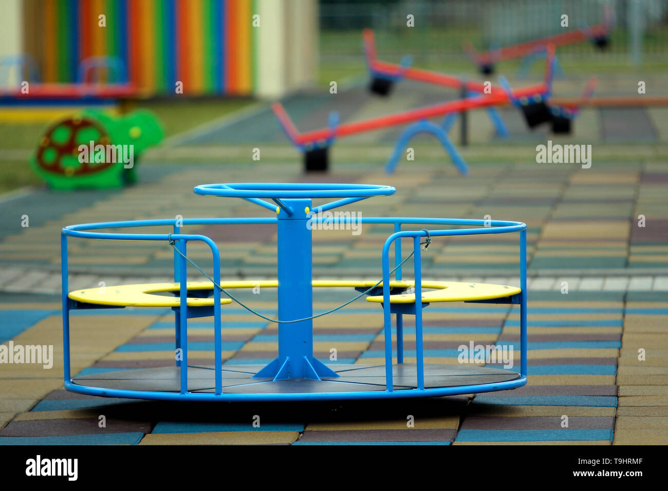 Beautiful playground in kindergarten with soft pavement, bright swings ...
