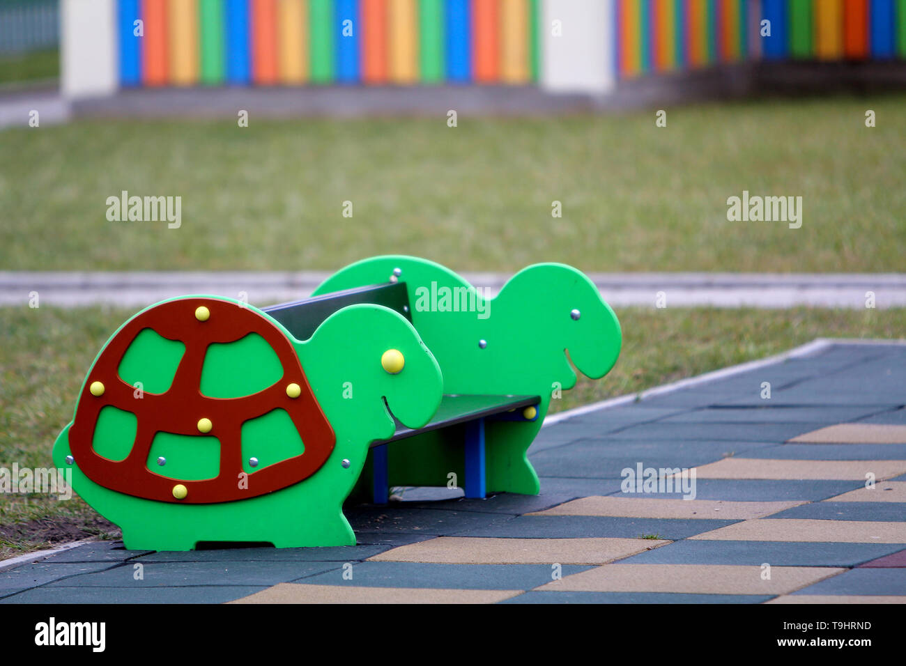 Bright colorful funny bench on nursery playground with soft rubber ...