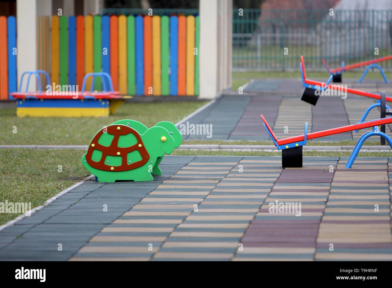 Bright colorful funny bench on nursery playground with soft rubber ...