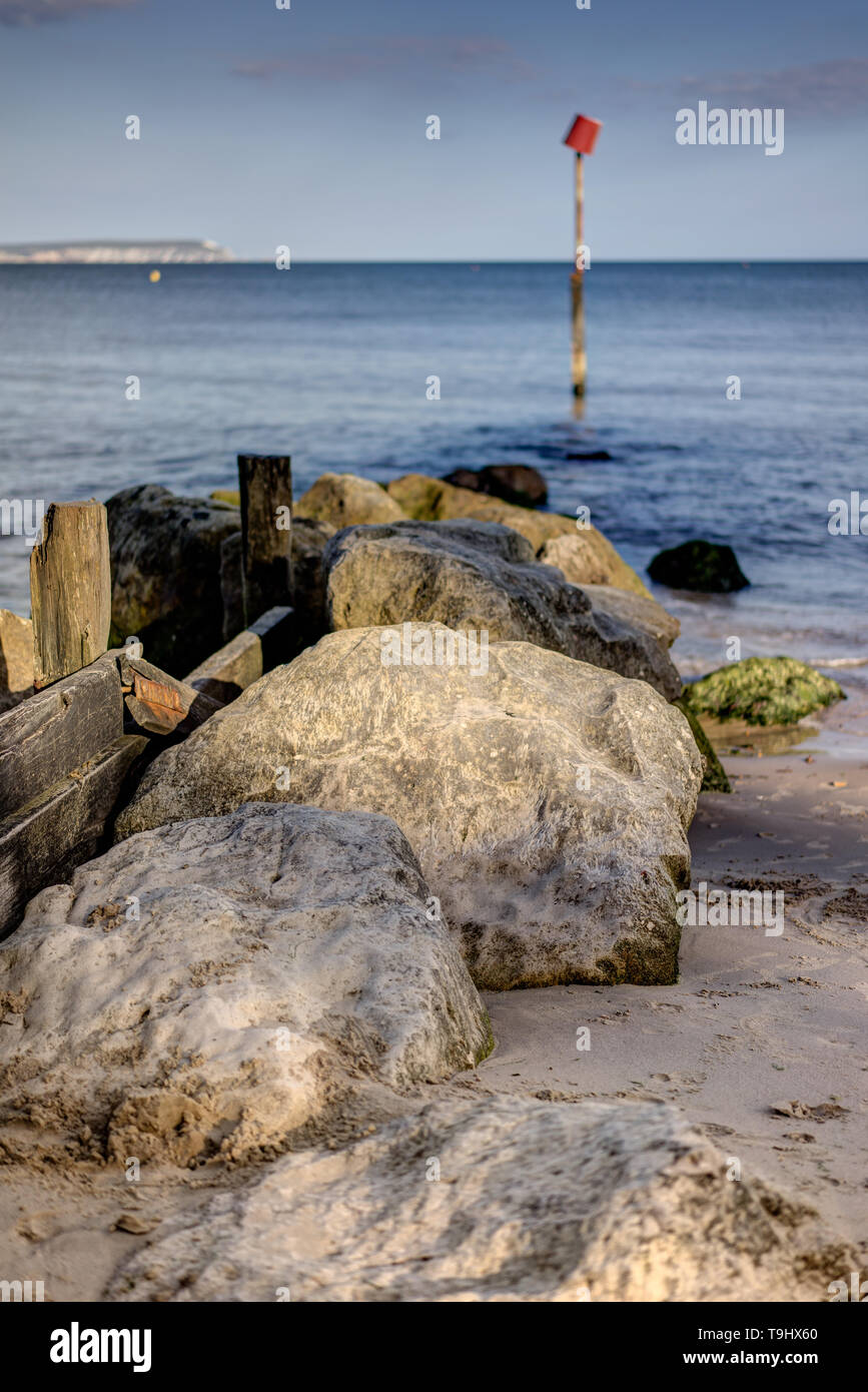 Groyne with rocks and marker post in the sea at Avon beach Mudeford ...