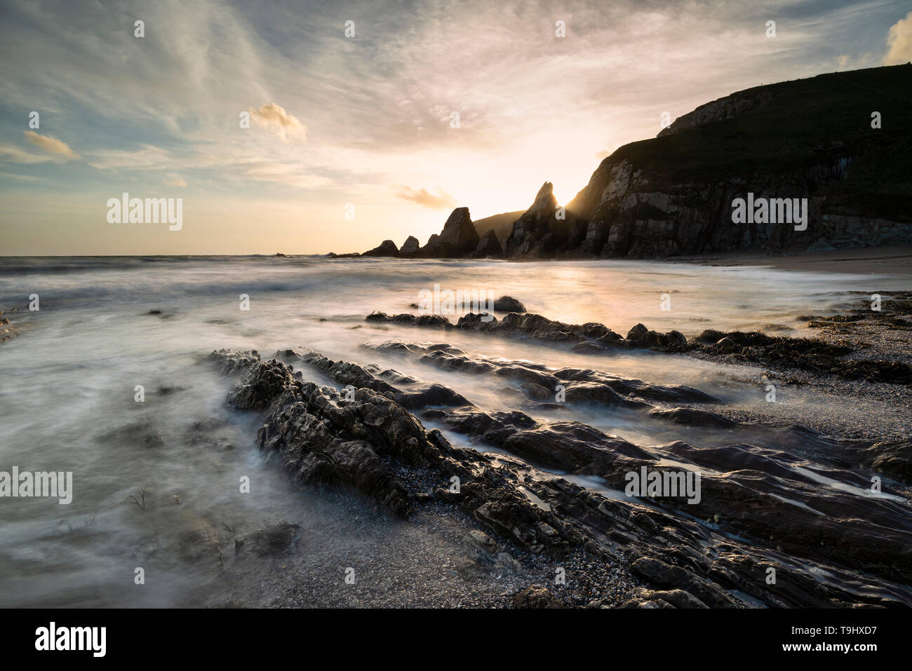 Beautiful sunset landscape image of Westcombe Beach in Devon England ...