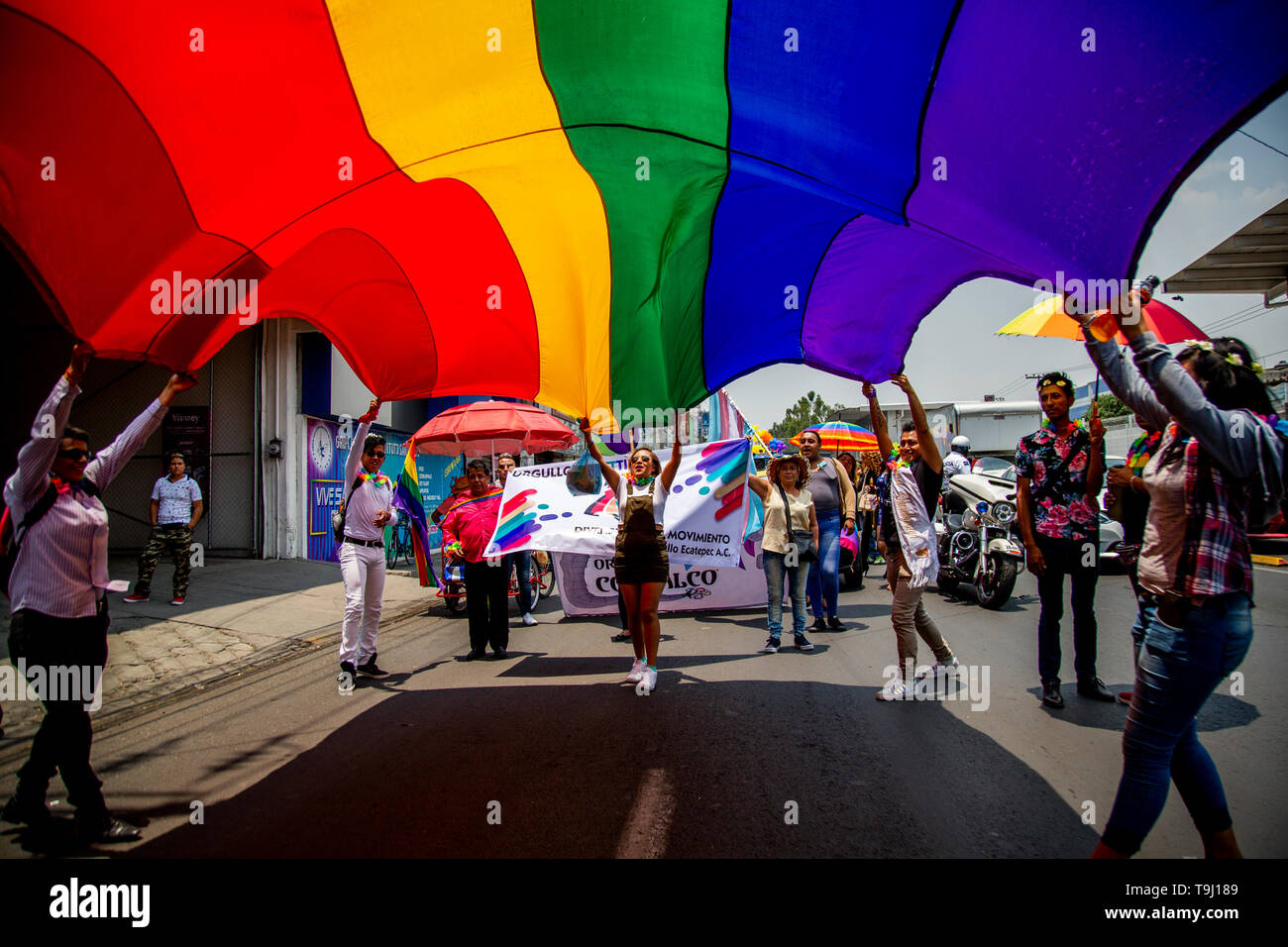 Ecatepec, Mexico. 18th May, 2019. Young people waving a rainbow flag in ...