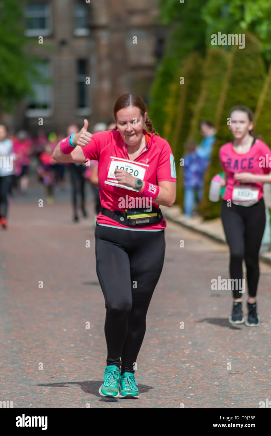 Glasgow, Scotland, UK. 19th May, 2019. A female runner in Glasgow Green ...
