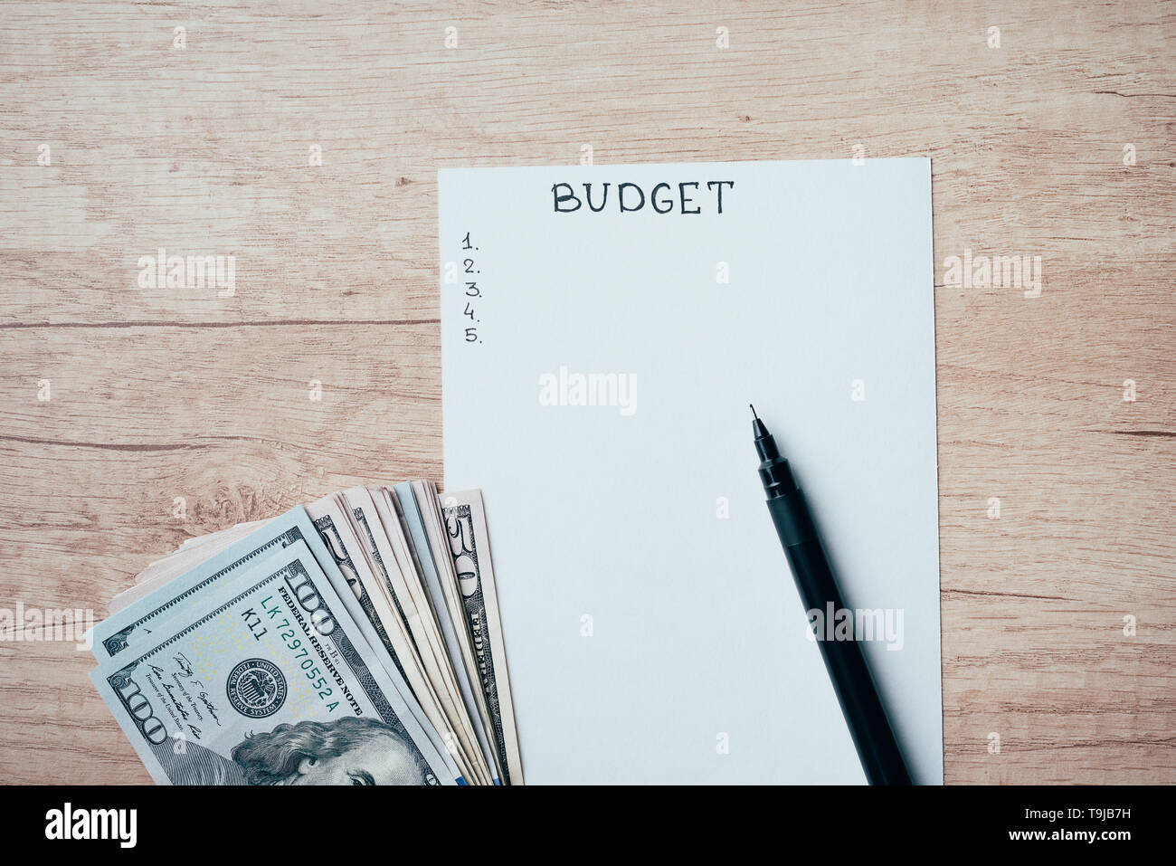 Notepad with word budget and dollar bills, top view. Planning budget ...