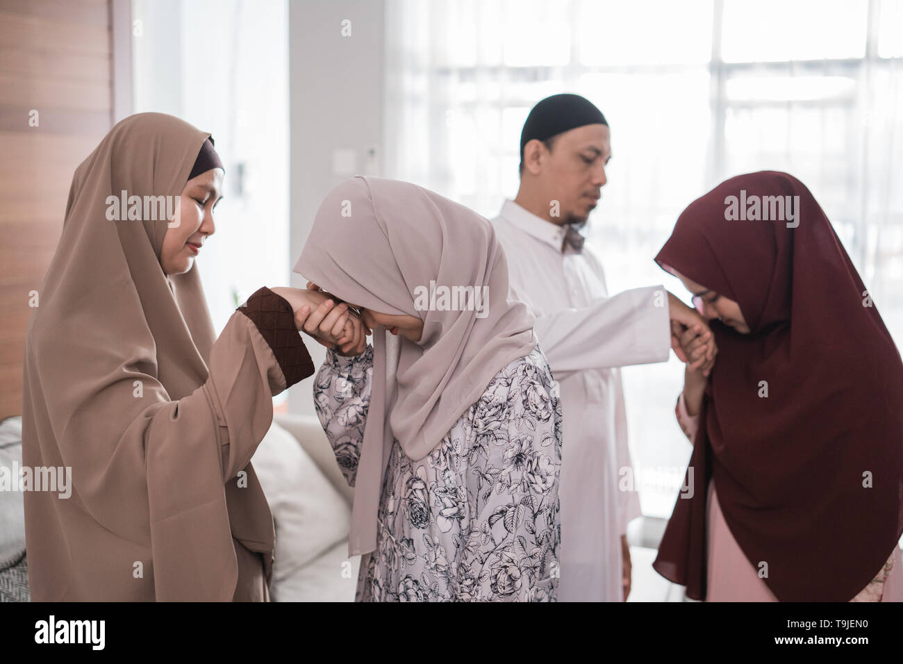 muslim family shake hand apologizing during the Eid mubarak ramadan ...