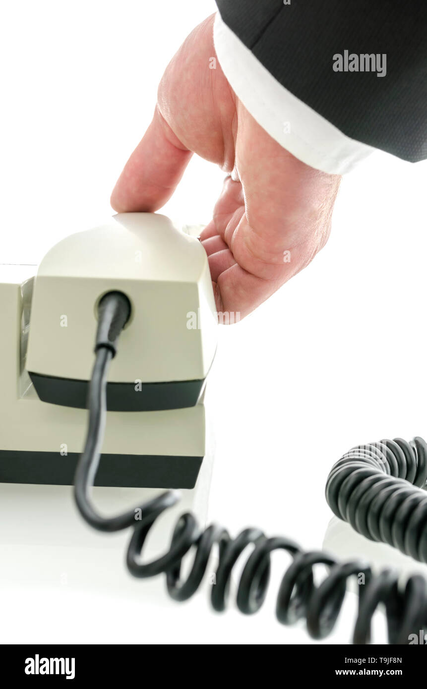 Rear view of business man hand picking or hanging up telephone receiver ...