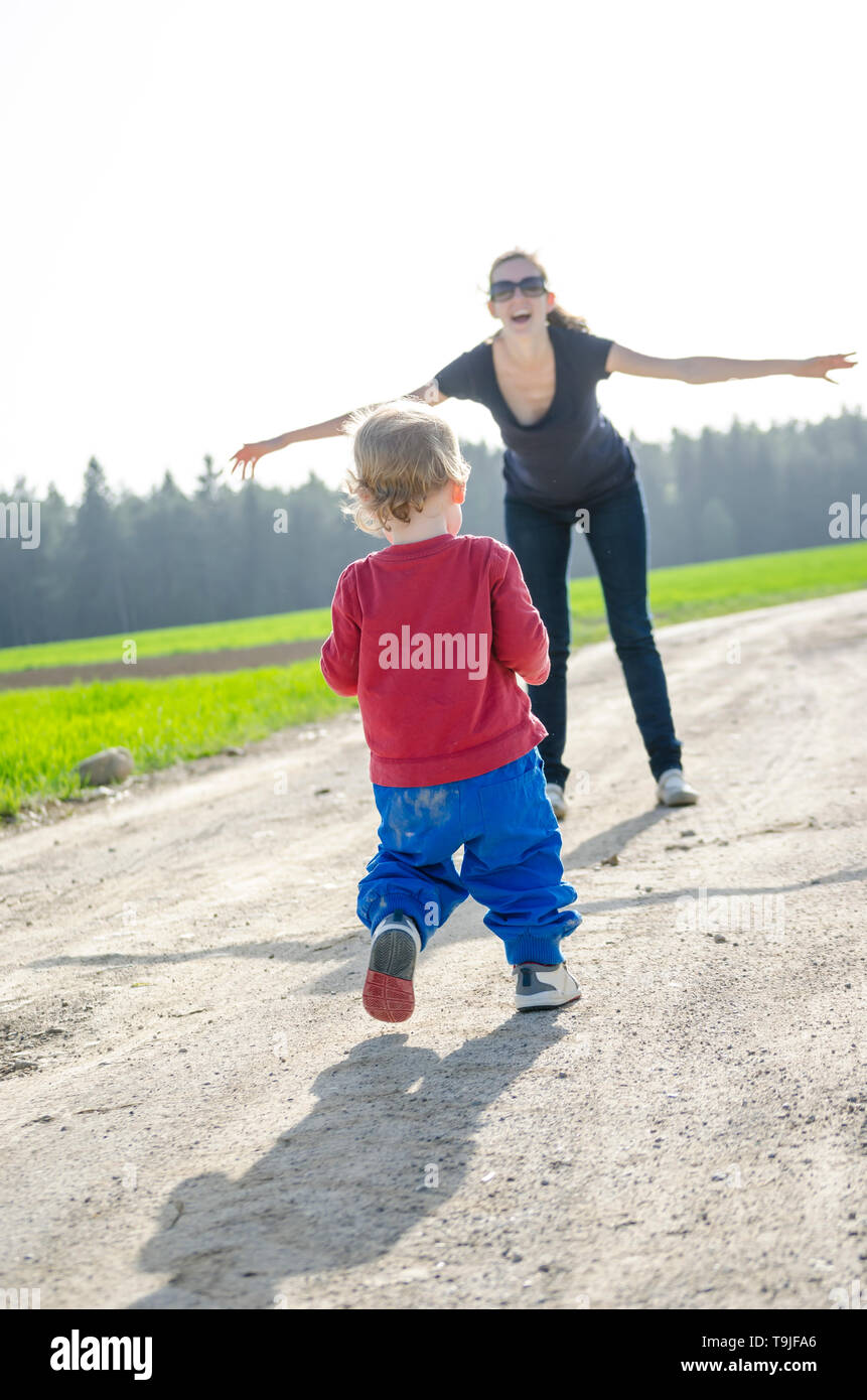 Son running to his mother who is waiting for him with open hands Stock ...