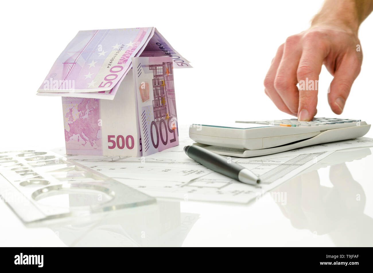 Male hand on a calculator calculating mortgage rates Stock Photo - Alamy