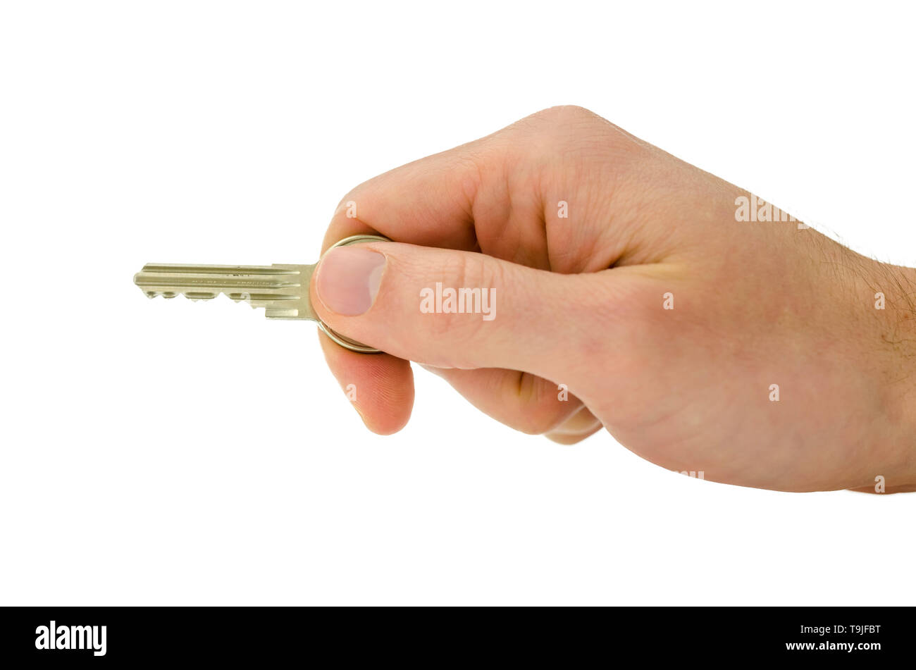 Male hand holding house key as if he is about to put it in a lock ...
