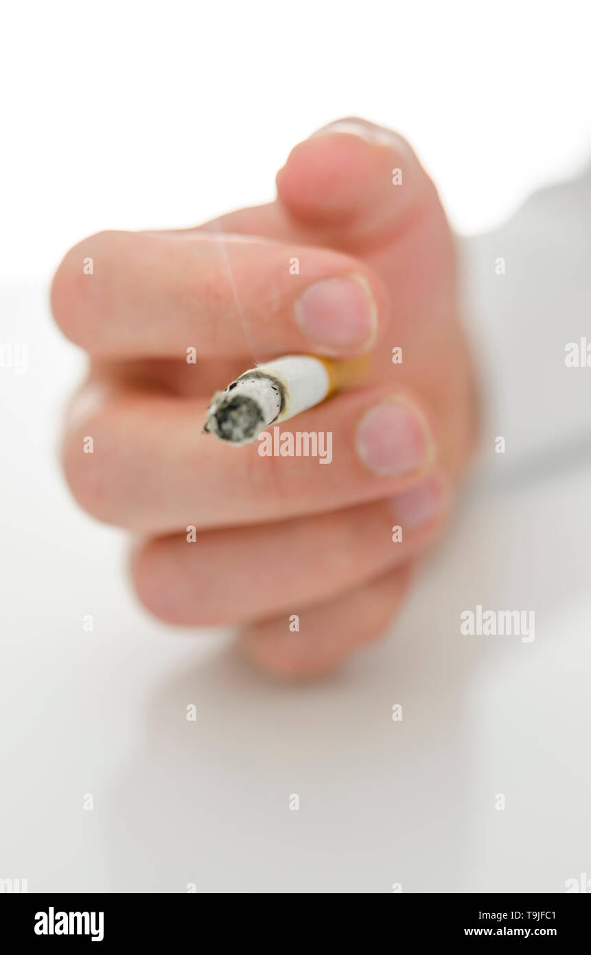 Closeup of male hand holding a cigarette. Isolated over white ...
