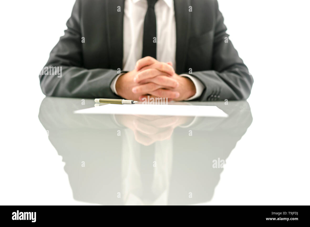 Front view of insurance agent sitting at his desk with papers and ...