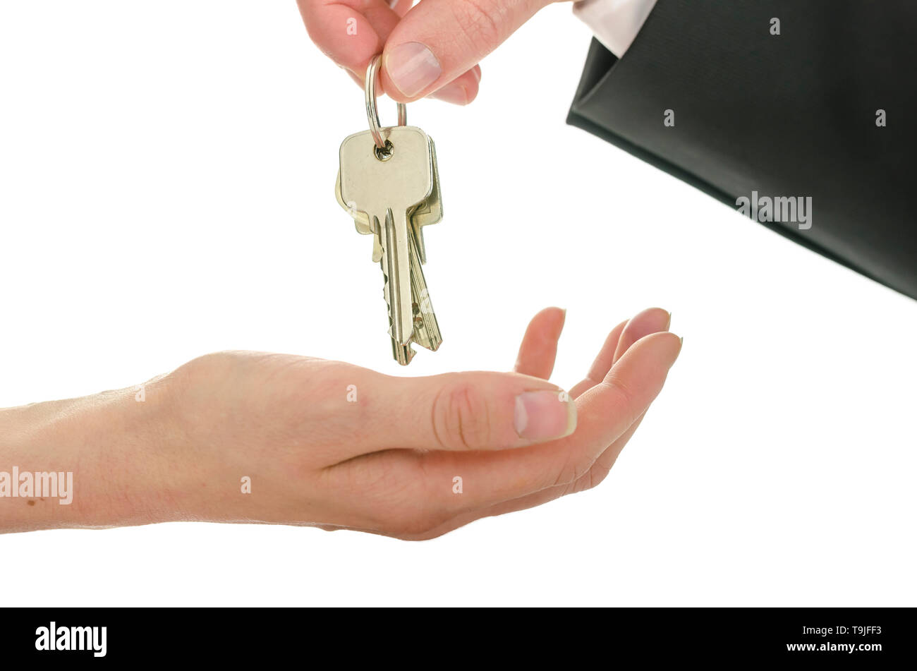 Man handing house keys over to a new owner. Isolated over white ...