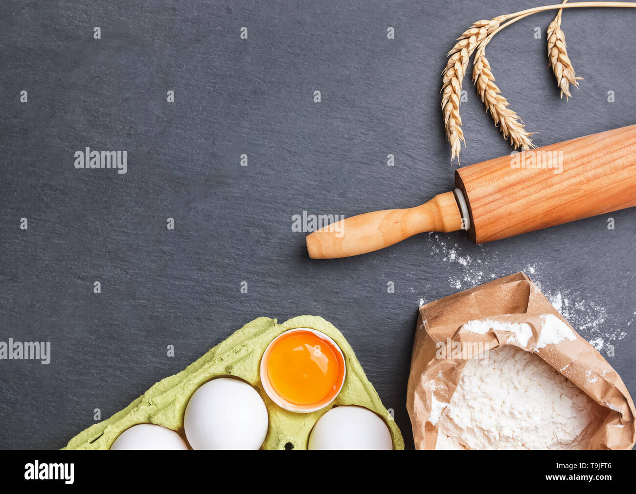 Baking ingredients and items on the black stone background, top view ...