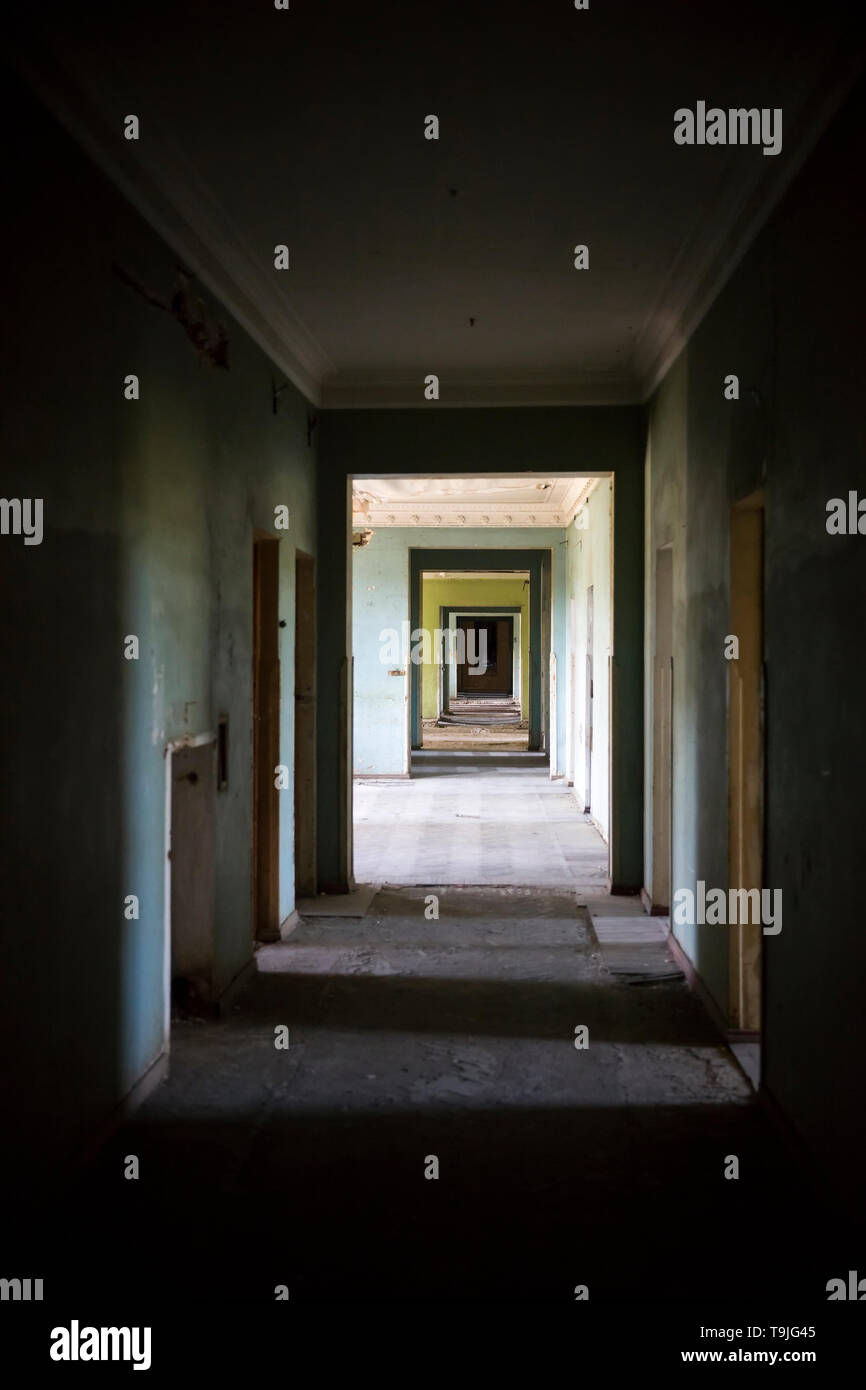 View at ruined hallway in the abandoned building Stock Photo - Alamy