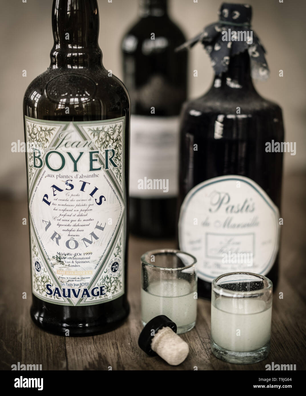 French pastis bottles and glasses with out of focus background Stock ...
