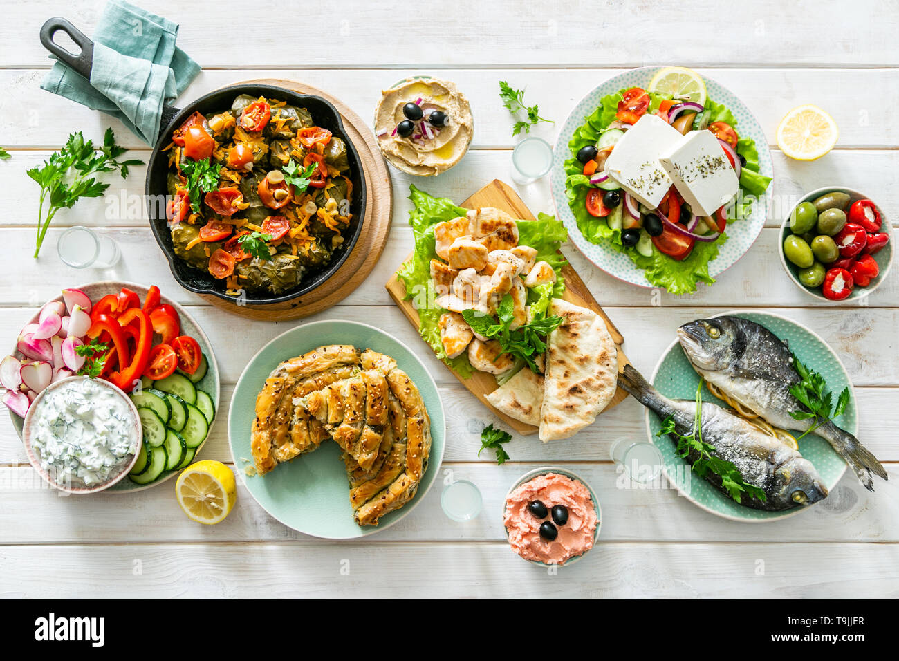 Selection of traditional greek food - salad, meze, pie, fish, tzatziki ...