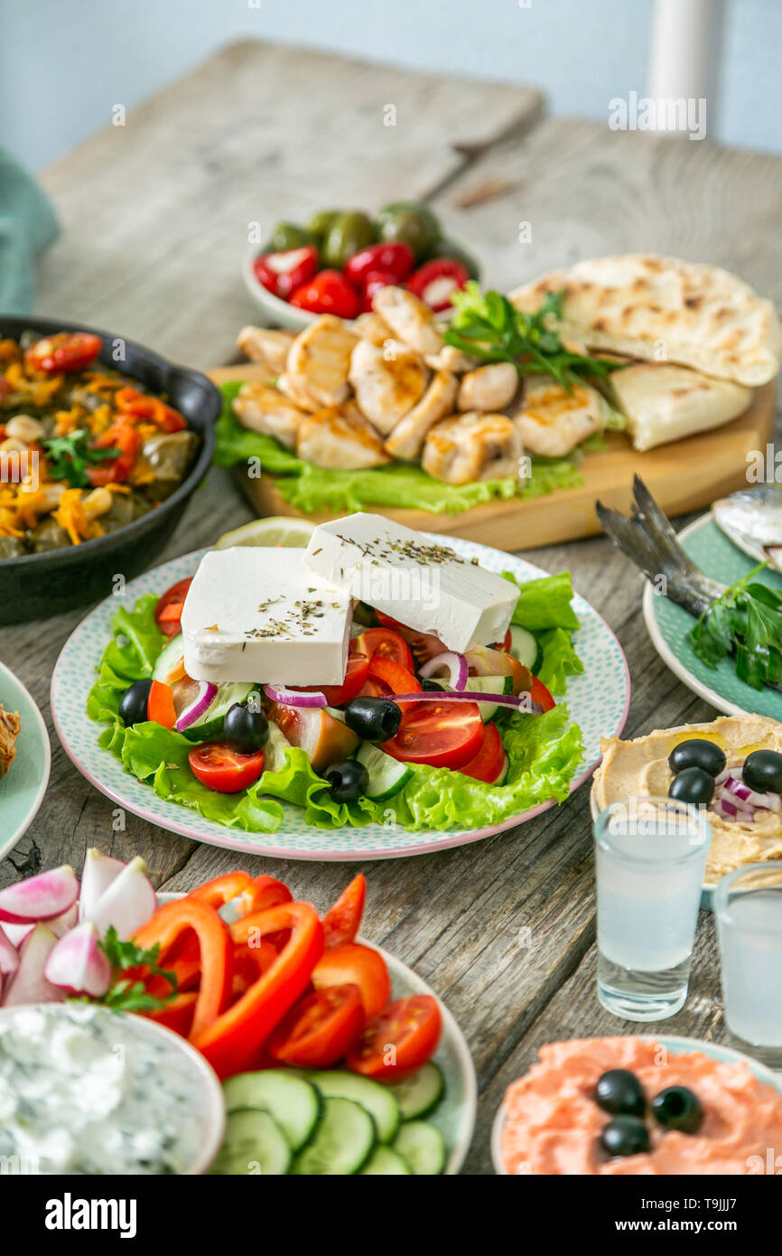 Selection of traditional greek food - salad, meze, pie, fish, tzatziki ...