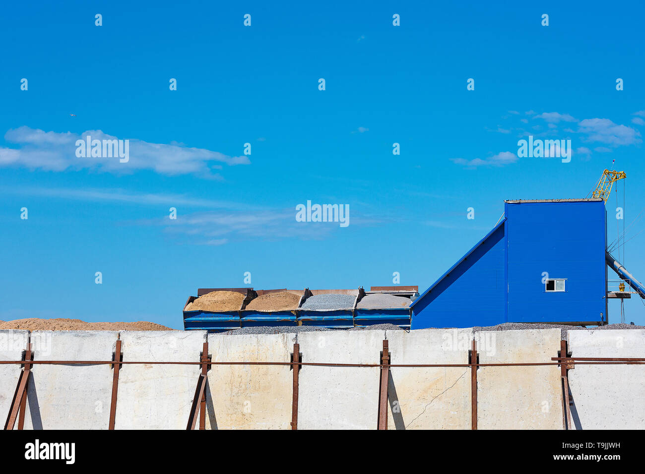 Components for the production of cement in containers against the blue ...
