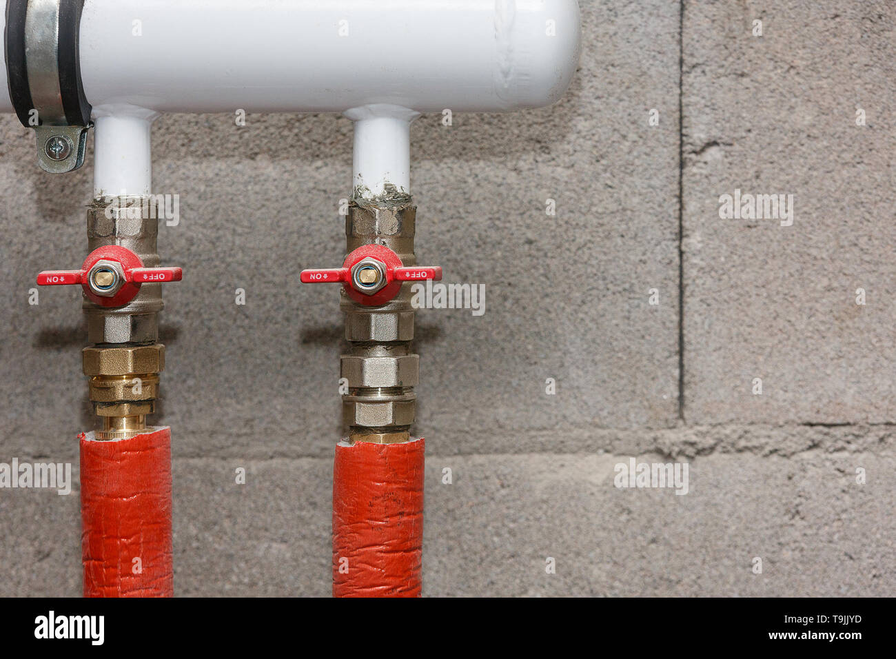 Sanitary cranes with water supply pipes, insulated with colored braids ...