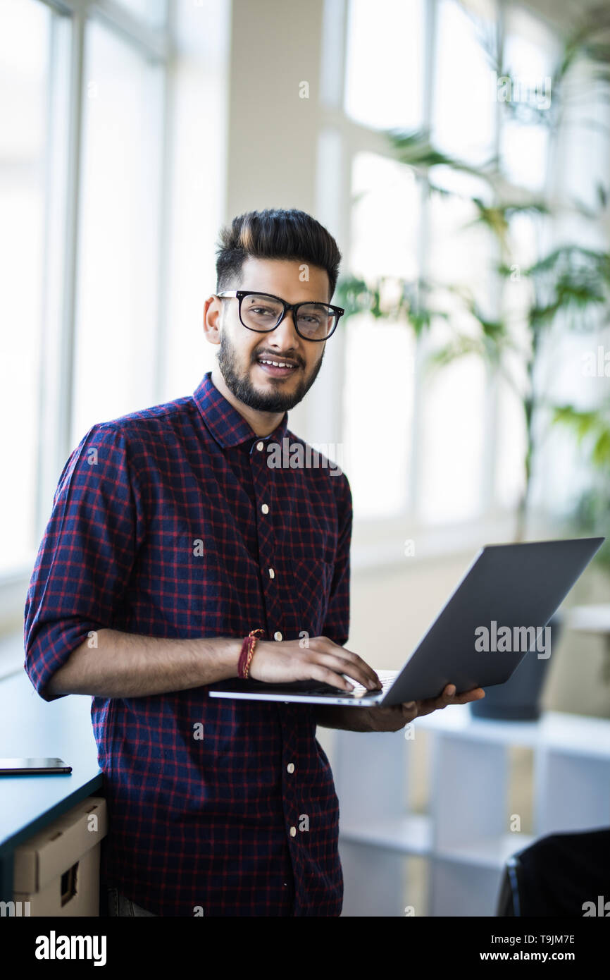 Confident businessman working on his computer in the office Stock Photo ...