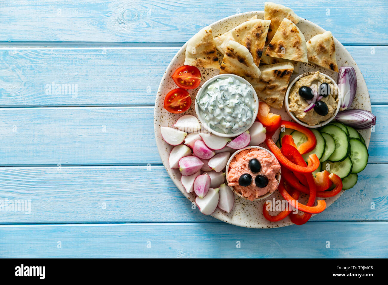 Selection of traditional greek food - salad, meze, pie, fish, tzatziki ...