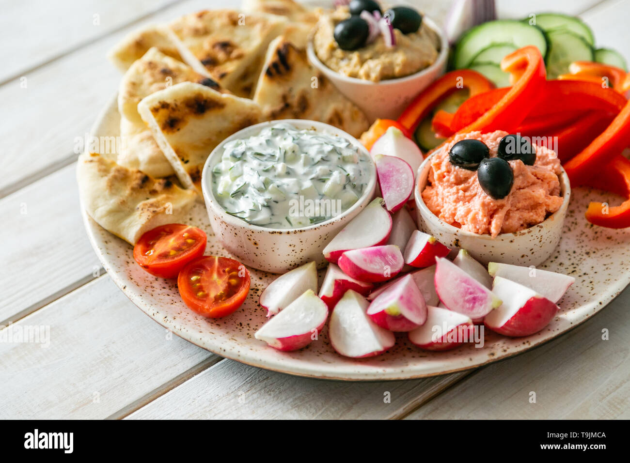 Selection of traditional greek food - salad, meze, pie, fish, tzatziki ...